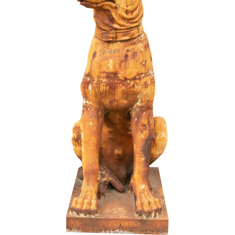 Old statue of a seated dog in cast iron